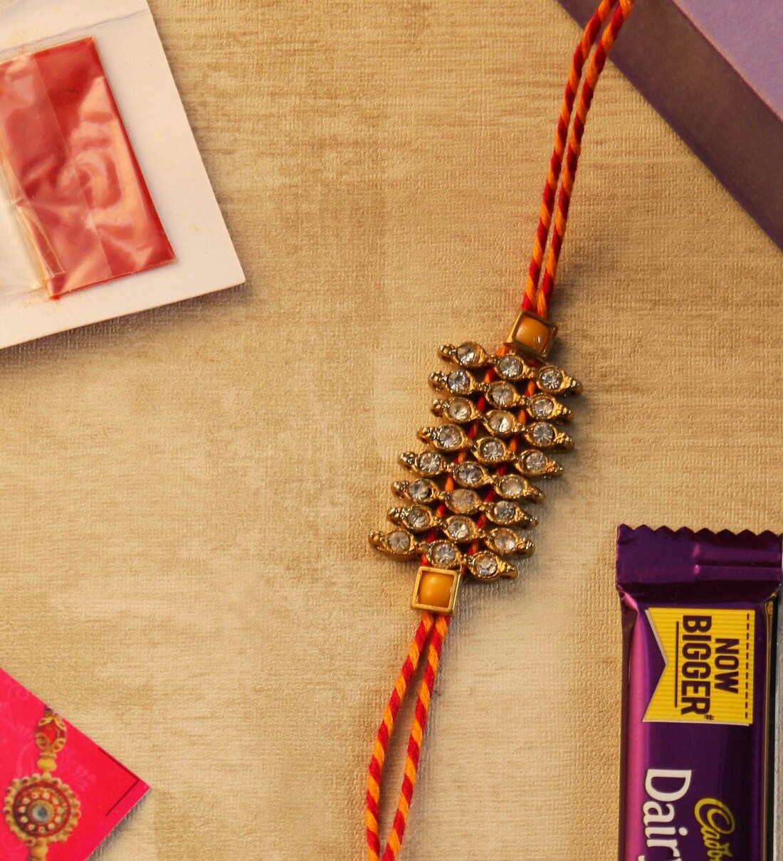 Buy Pretty Ad Studded Golden Rakhi By Aapno Rajasthan Online - Rakhis ...