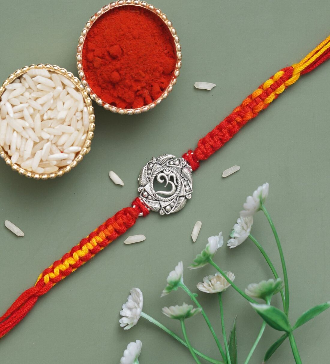 Buy Traditional Silver Om Symbol Rakhi with Red and Yellow Thread, and ...